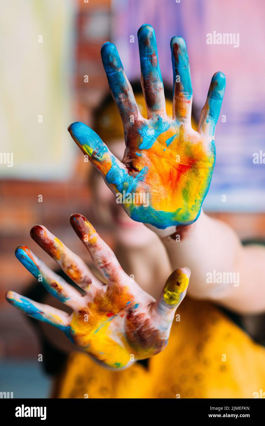 creative hobby artist hands blue yellow paint Stock Photo - Alamy