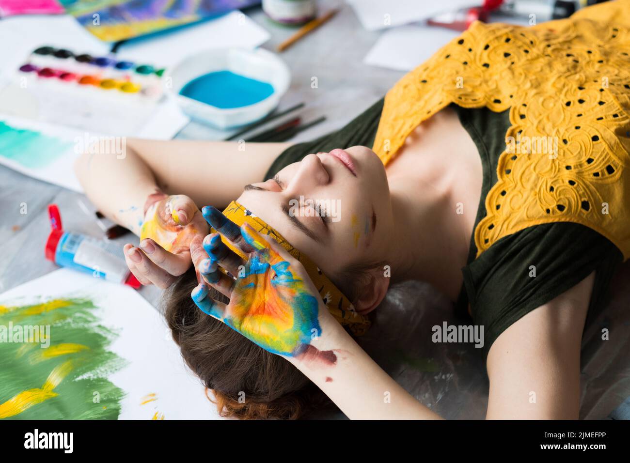 art therapy tired young lady floor hands paint Stock Photo - Alamy