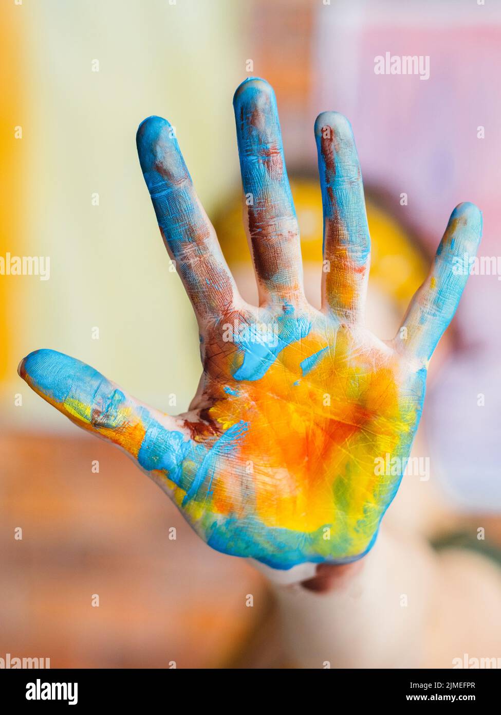 finger painting art trend blue yellow colored hand Stock Photo - Alamy