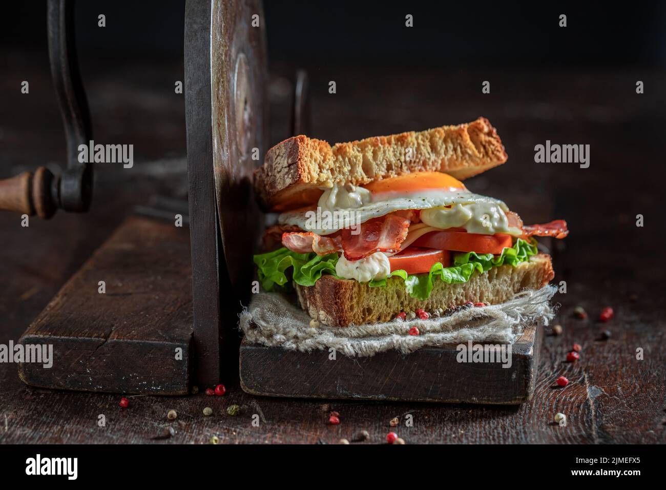 Tasty and homemade toasted sandwich with egg, tomato and bacon. British ...