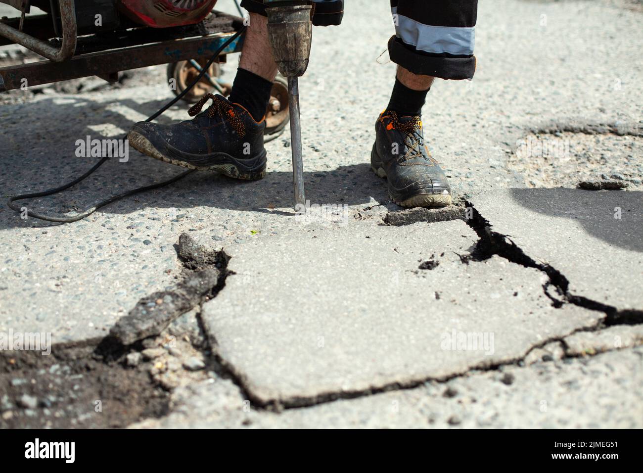 He removes the asphalt with a jackhammer. Removing the asphalt layer ...