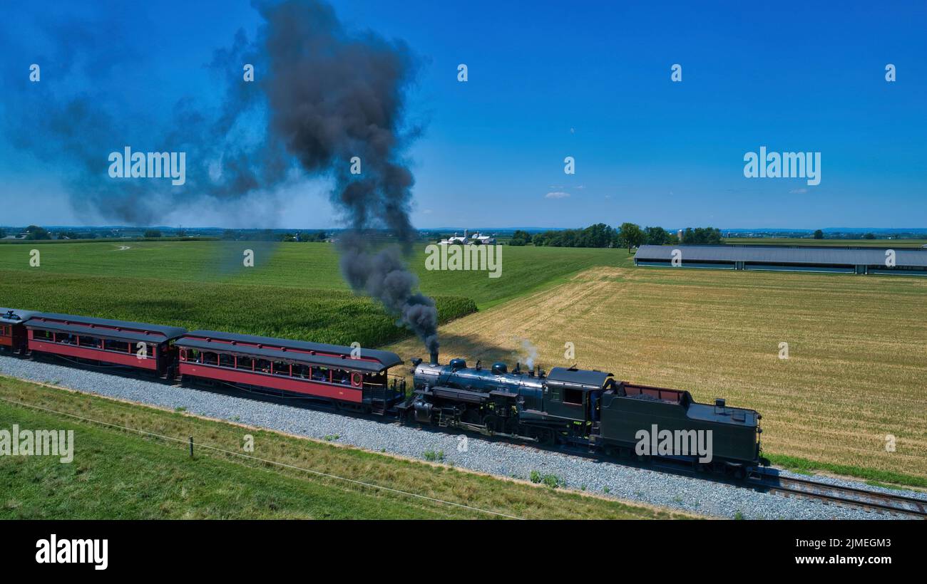 Aerial View of a Steam Locomotive Traveling Across Farmland Landscape ...