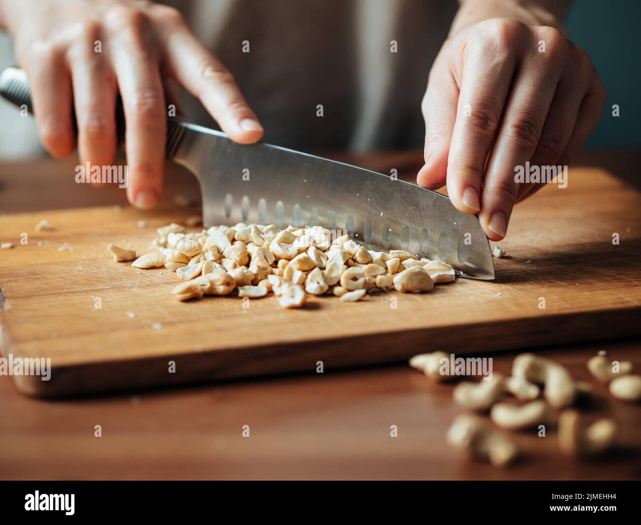 Female hands chopping cashew Stock Photo - Alamy