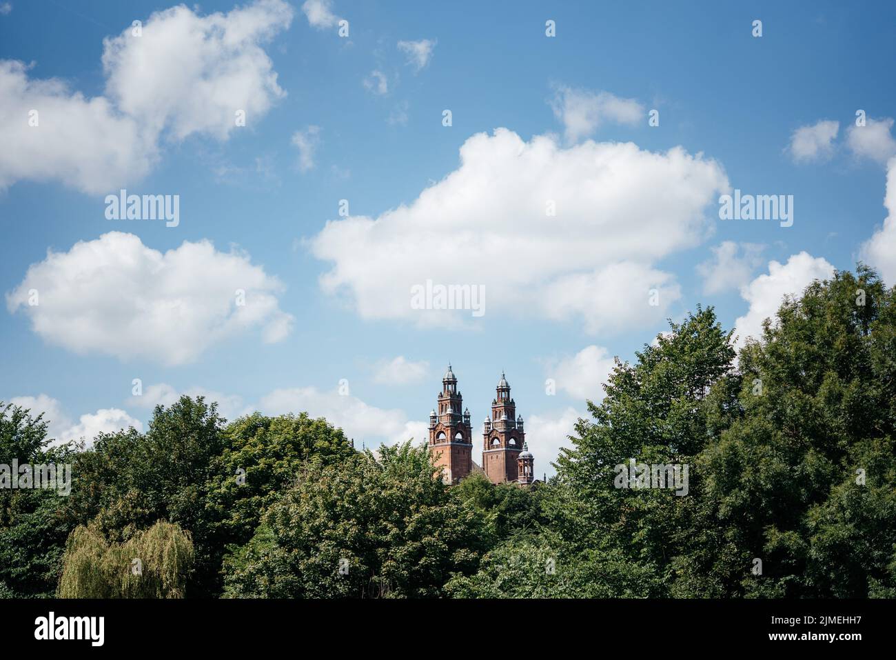 A view of green trees against blue sky with white clouds in Kelvingrove ...