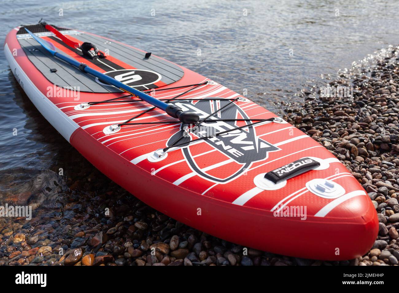 SUP board on the river bank. Paddle board on the lake shore. Supboard ...