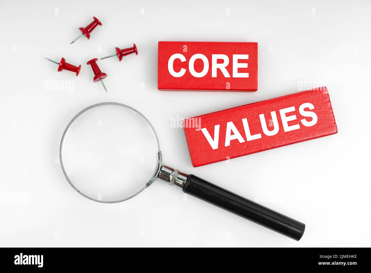 Business concept. On a white background, a magnifying glass and red ...