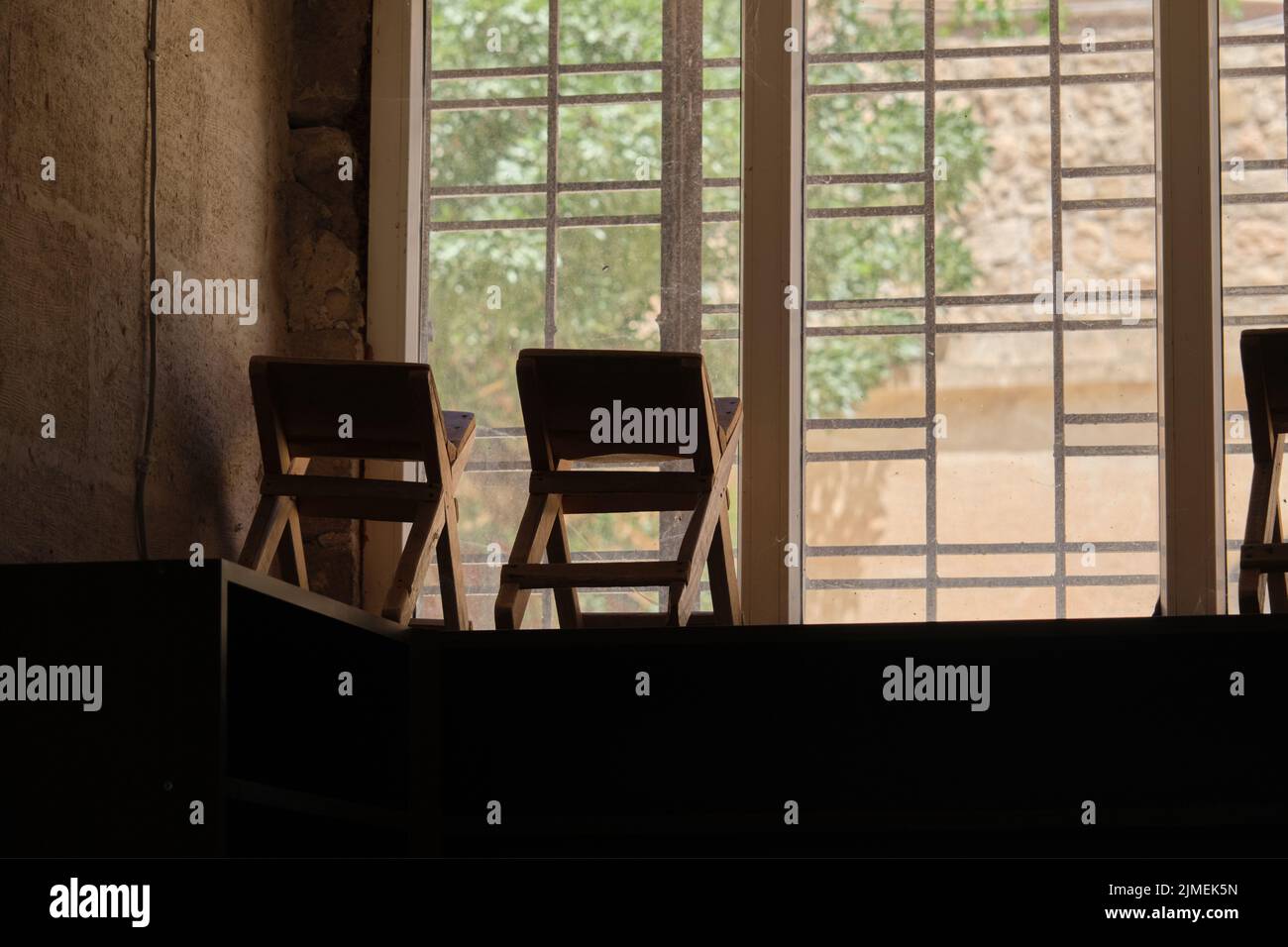 low angle view of interior of a mosque from window, koran table, wooden ...