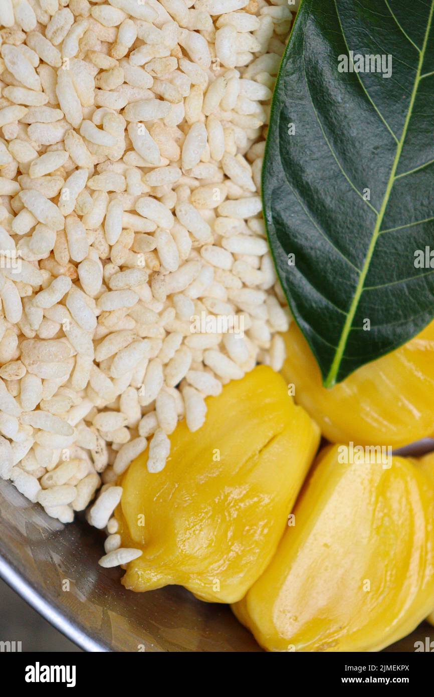 tasty and healthy jackfruit cloves with leaf and puffed rice on plate ...