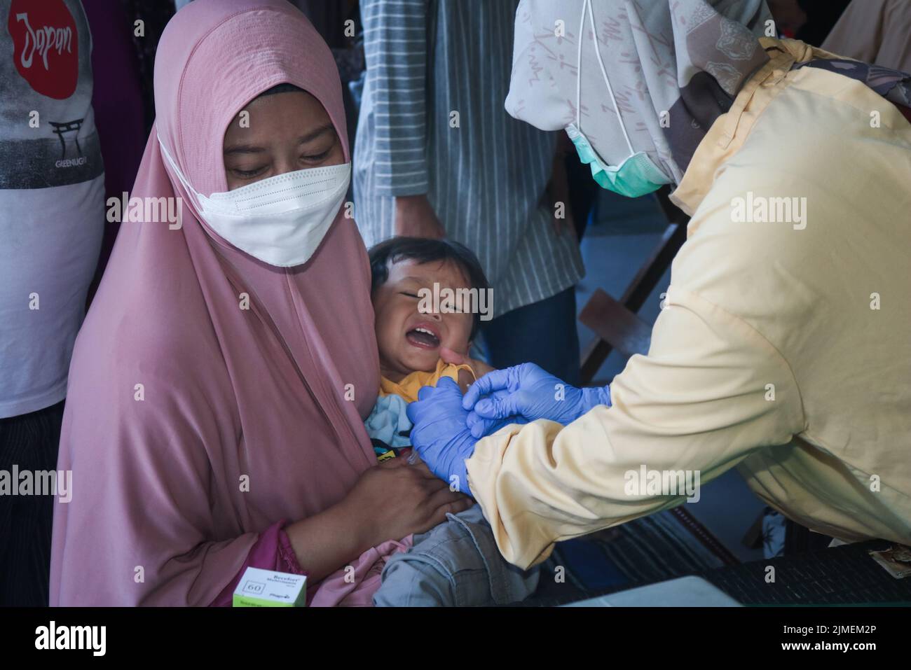 Malang, East Java, Indonesia. 6th Aug, 2022. A crying baby is immunized by a medical officer ...