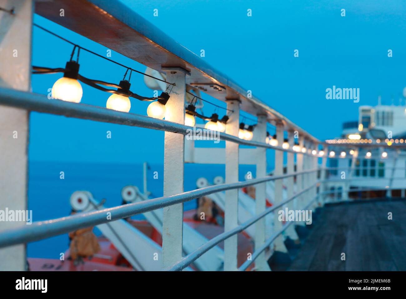 Blur On the open deck of a cruise ship on a calm day, with the coast in ...