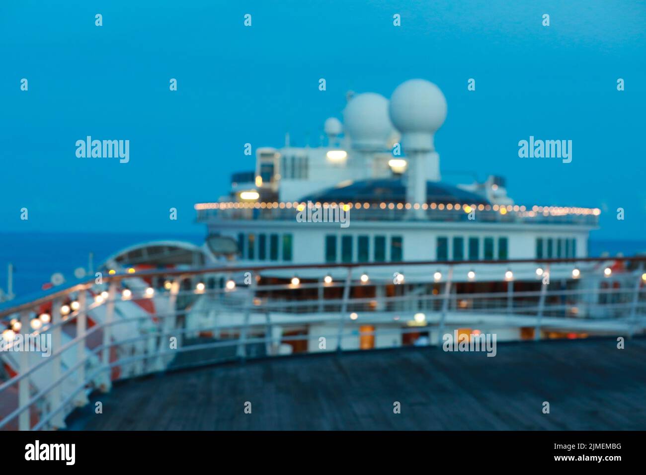 Blur On the open deck of a cruise ship on a calm day, with the coast in ...