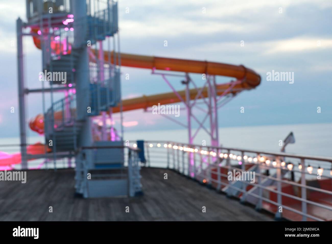Blur On the open deck of a cruise ship on a calm day, with the coast in ...