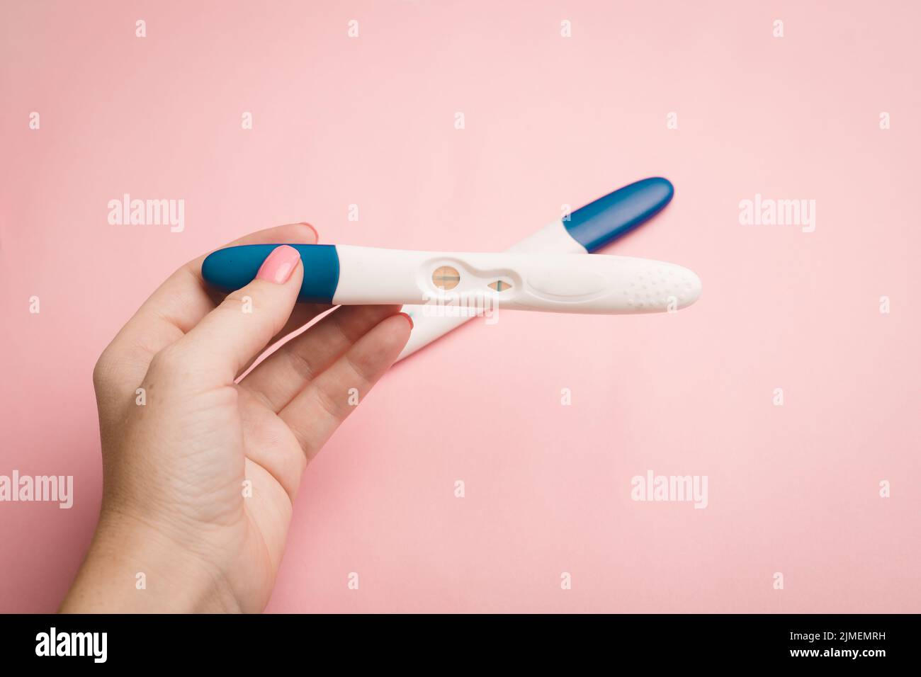 Pregnancy test in hand on a pink background . Positive test. Pregnancy ...