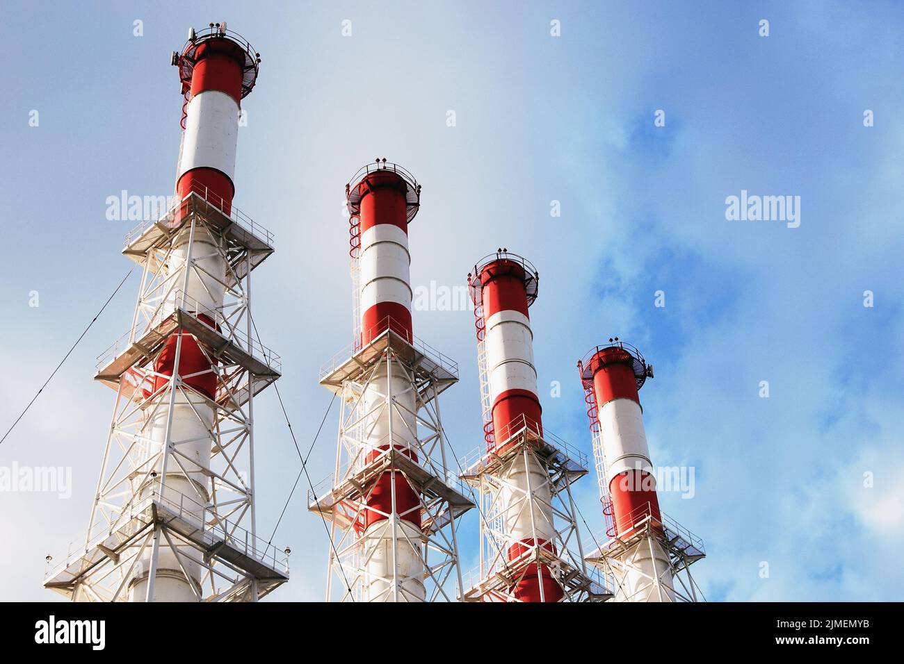 Boiler station pipes against blue sky, central steam heating system ...