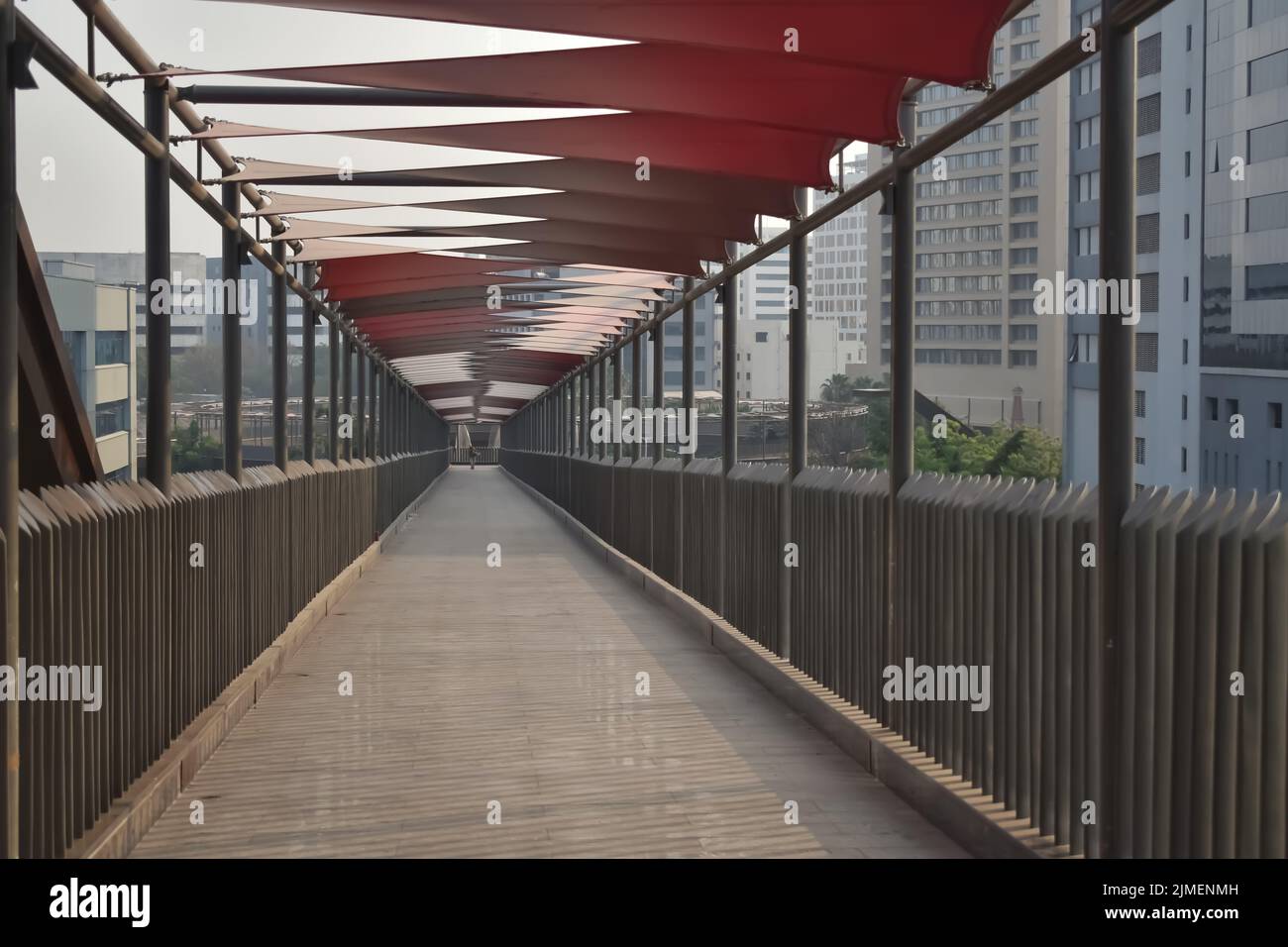 A Picture of long corridor or Skywalk in an urban area with high raised ...