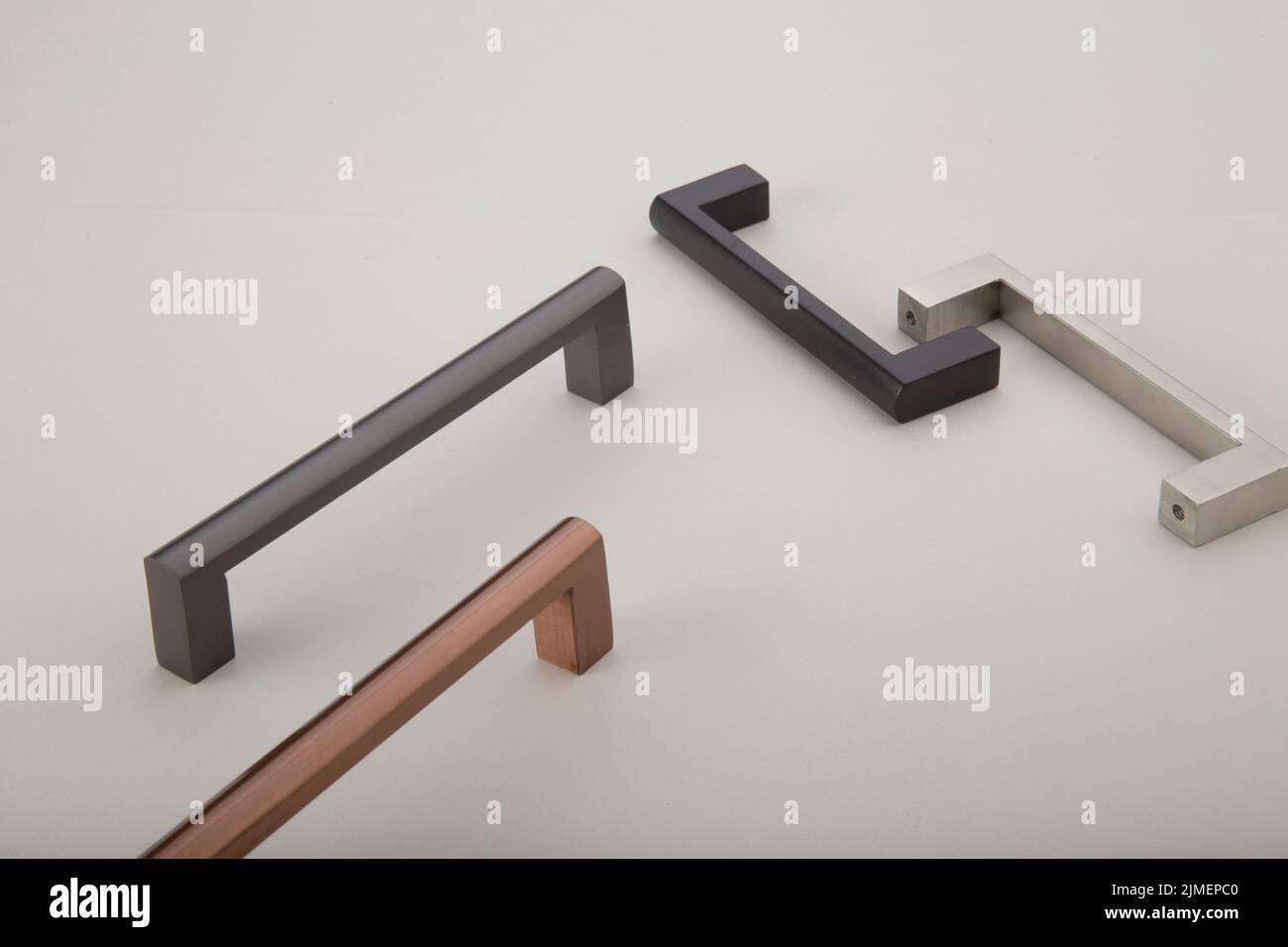 A variety of metal pull handles on gray surface Stock Photo - Alamy