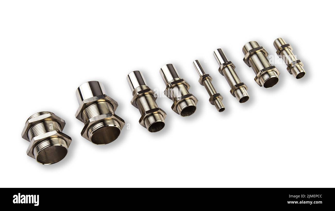 A row of steel connector tubes of different width on white surface ...