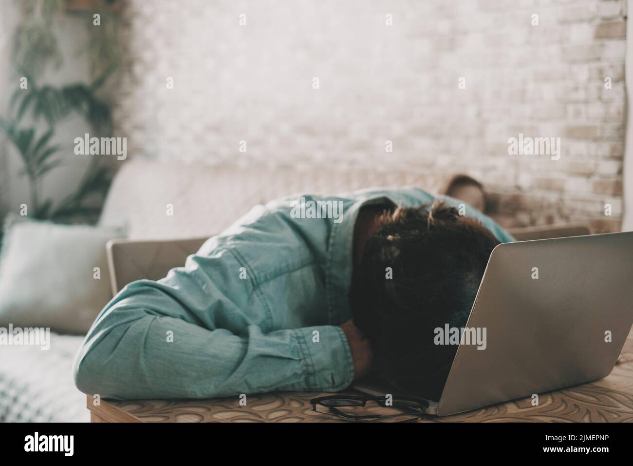 Overworked freelance asleeped on the laptop keyboard. One man sleeping ...