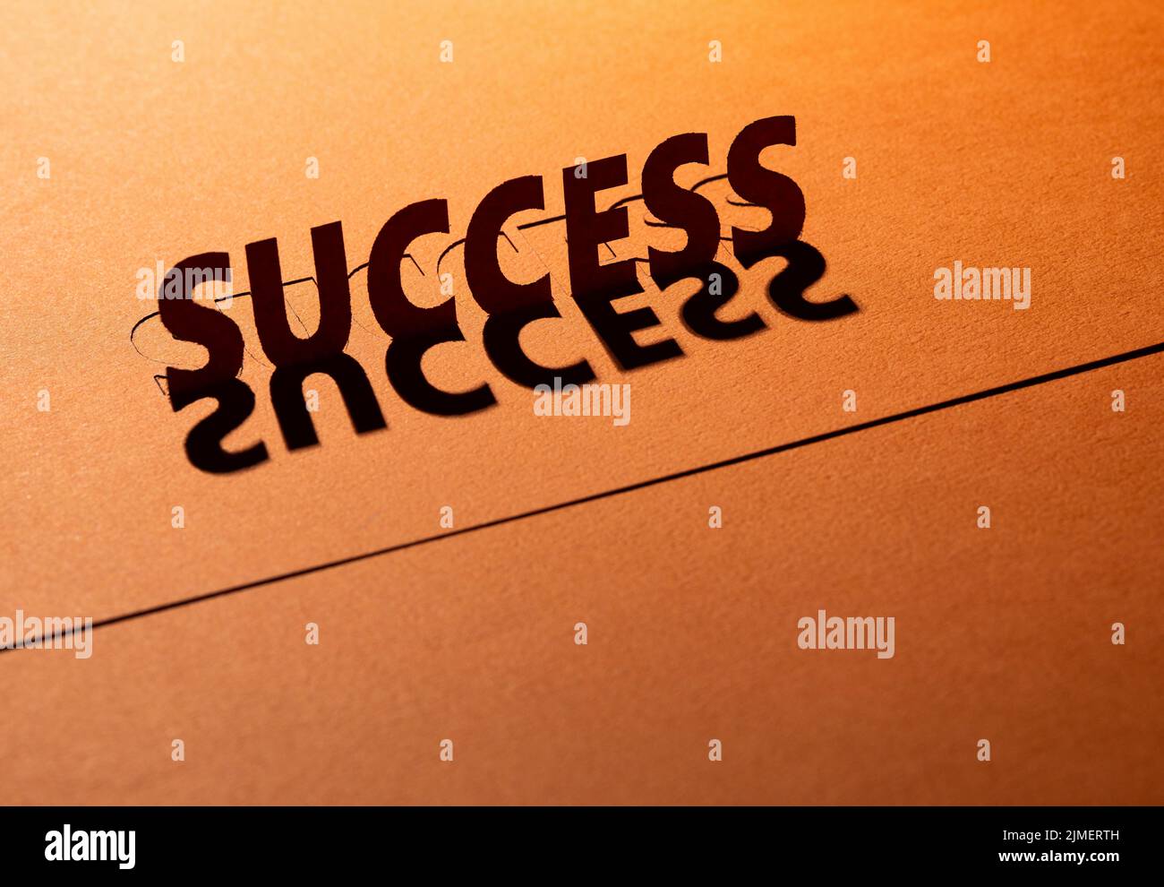 Success word cutting and standing from paper, lit from behind and ...