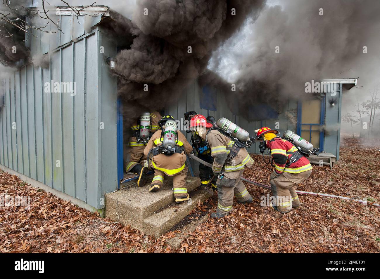 Firefighters make entry into a building as members of the East Hampton ...