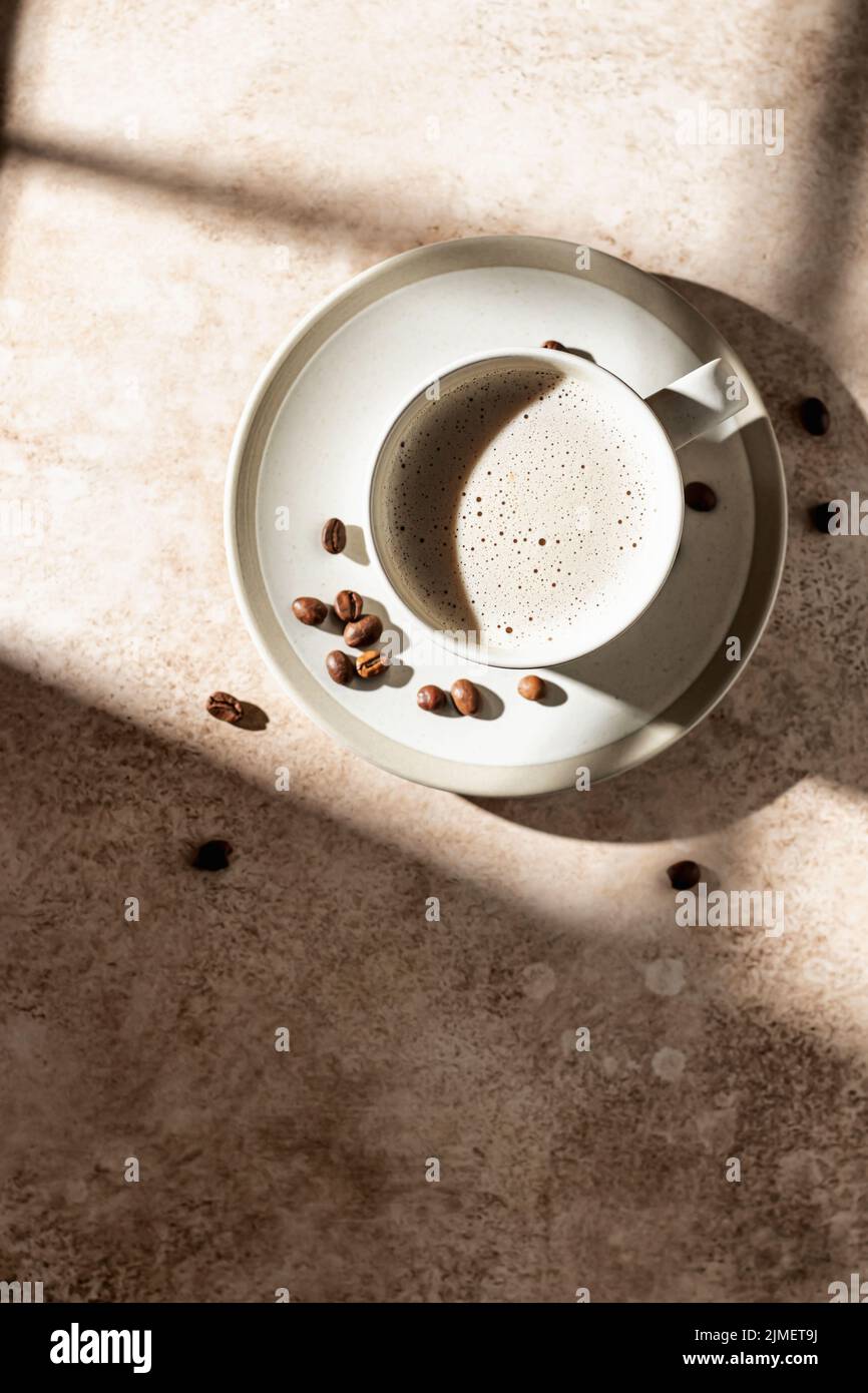 Cappuccino with foam in hard light with beautiful shadows isolated ...