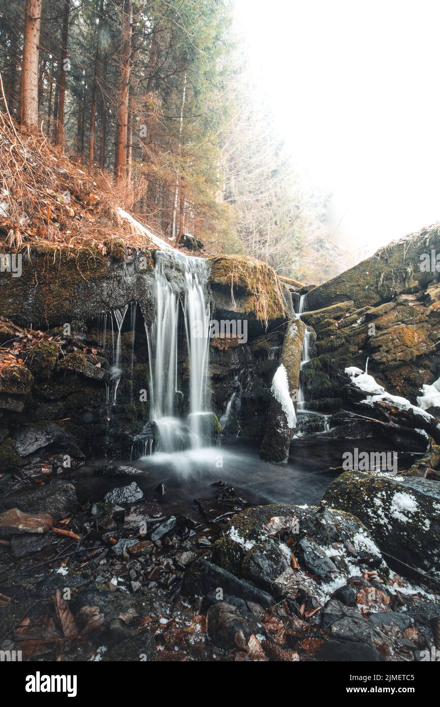Clear water photographed with long exposure time through flowing rocks ...