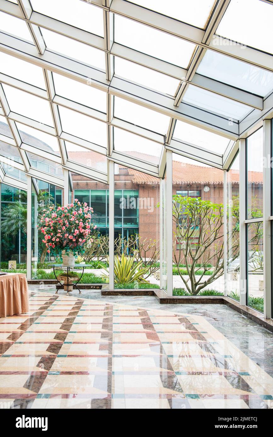 Empty hall interior with french windows and flowers Stock Photo - Alamy