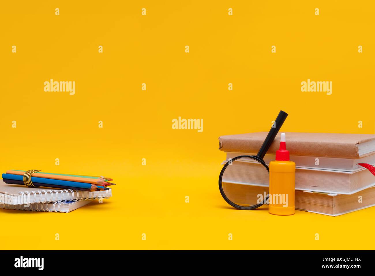 Back to school, stationery and books on yelow background with copyspace ...