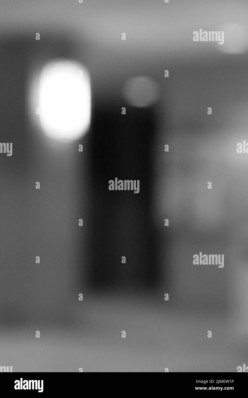 Blurry dreamy abstract view of the interior of a building in black and ...
