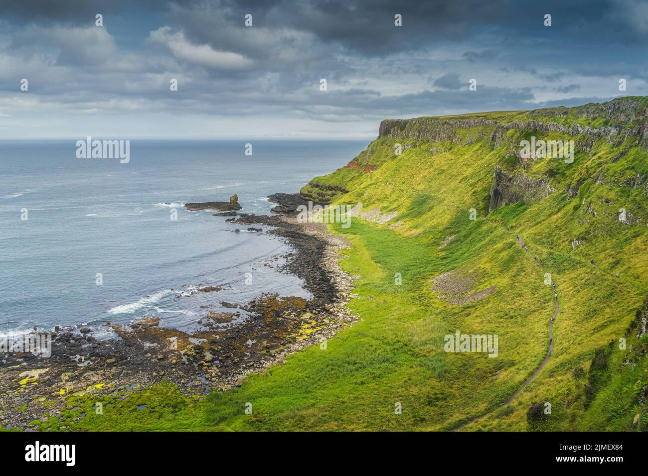 Tourists on the path to The Amphitheatre in Giants Causeway, Northern ...