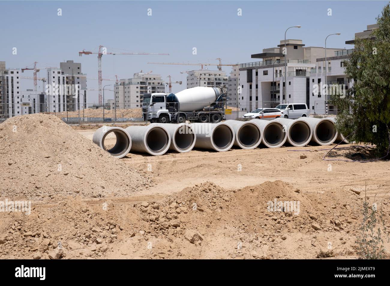 Laying sewer Concrete drainage pipe between large residential areas ...