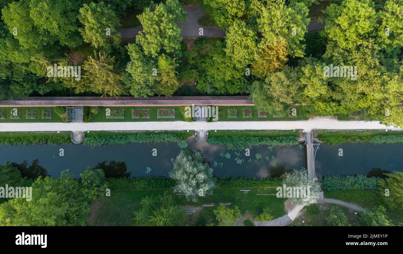 An aerial view of a park with trees and a narrow river in Neo-Ulm ...