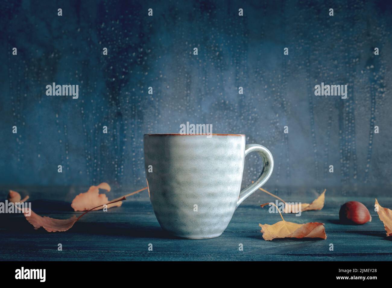 Tea with autumn leaves on a rainy day Stock Photo - Alamy