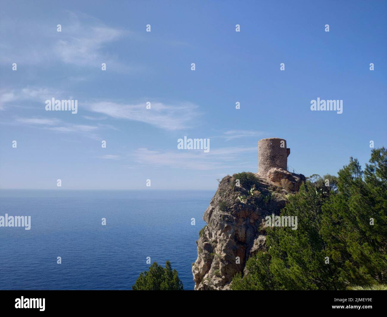 Torre del Verger watchtower on a cliff in Mallorca, Spain. Blue sea ...