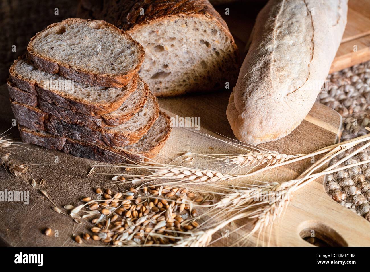 Rustic bread variety close up with wheat seeds and wood Stock Photo - Alamy