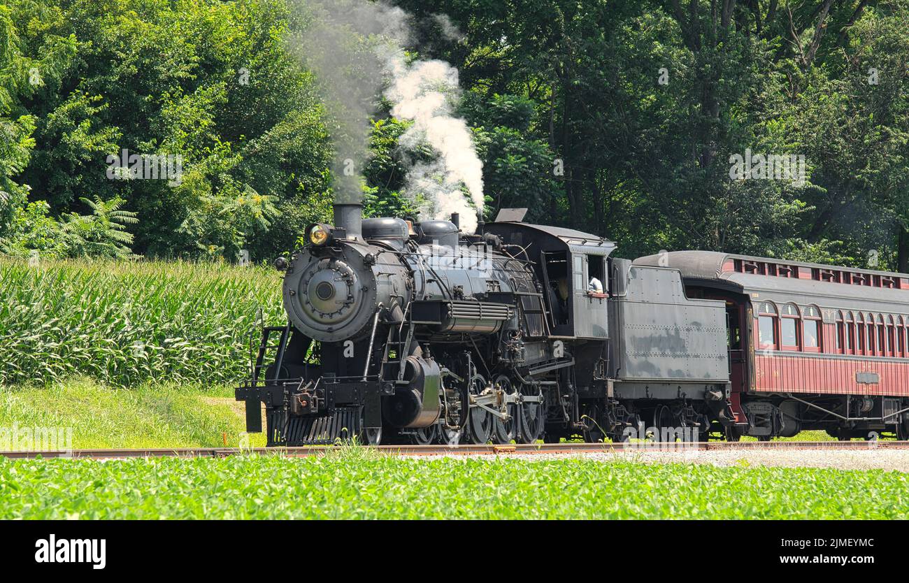 View of an Antique Restored Steam Passenger Train Blowing Smoke and ...