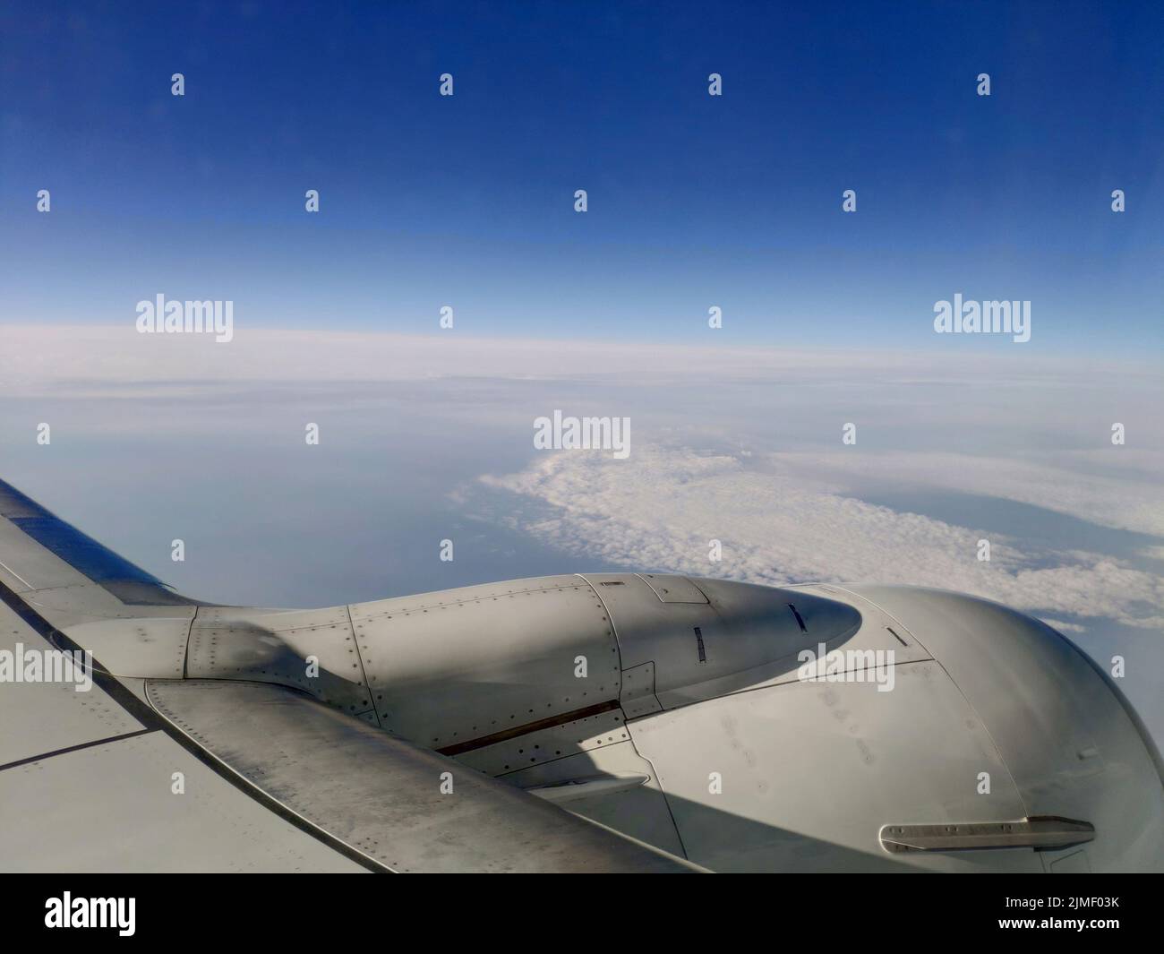 View from plane window on white turbine ang wing. Airplane flying over the clouds Stock Photo ...