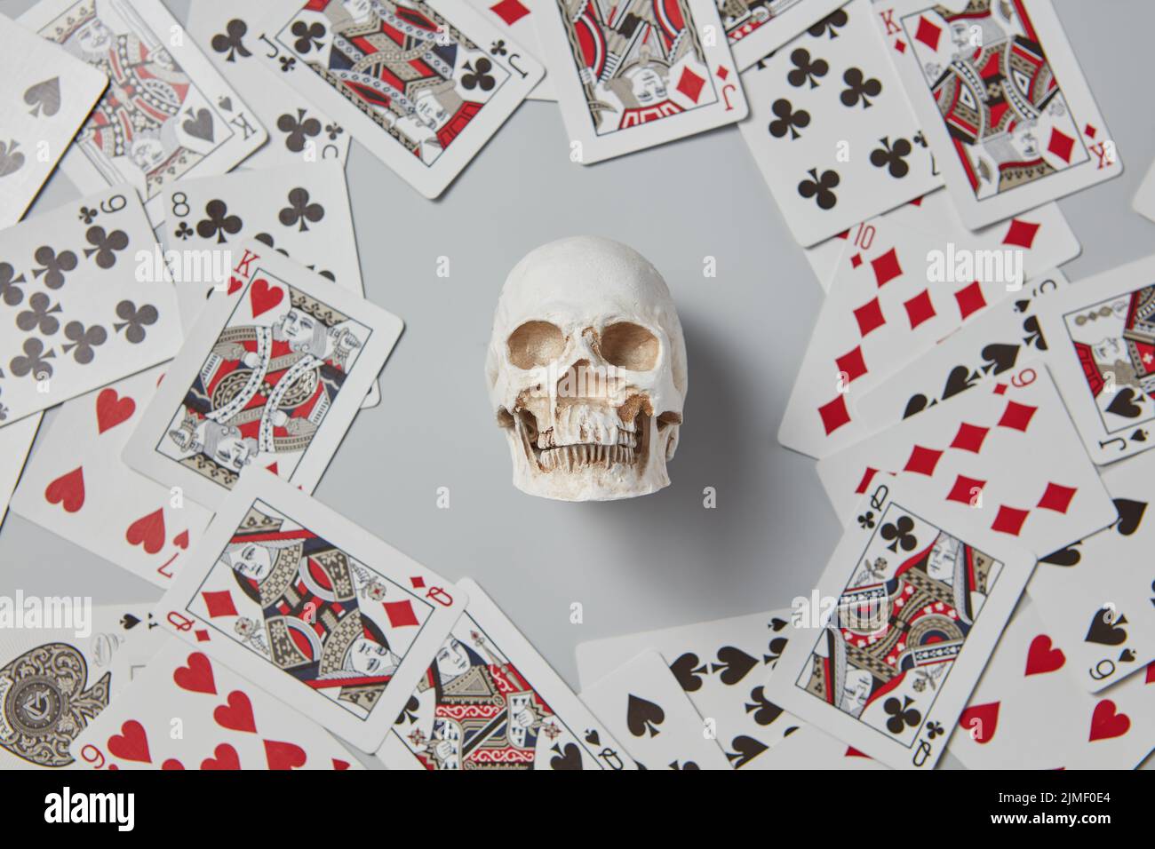 Playing cards with human skull Stock Photo - Alamy