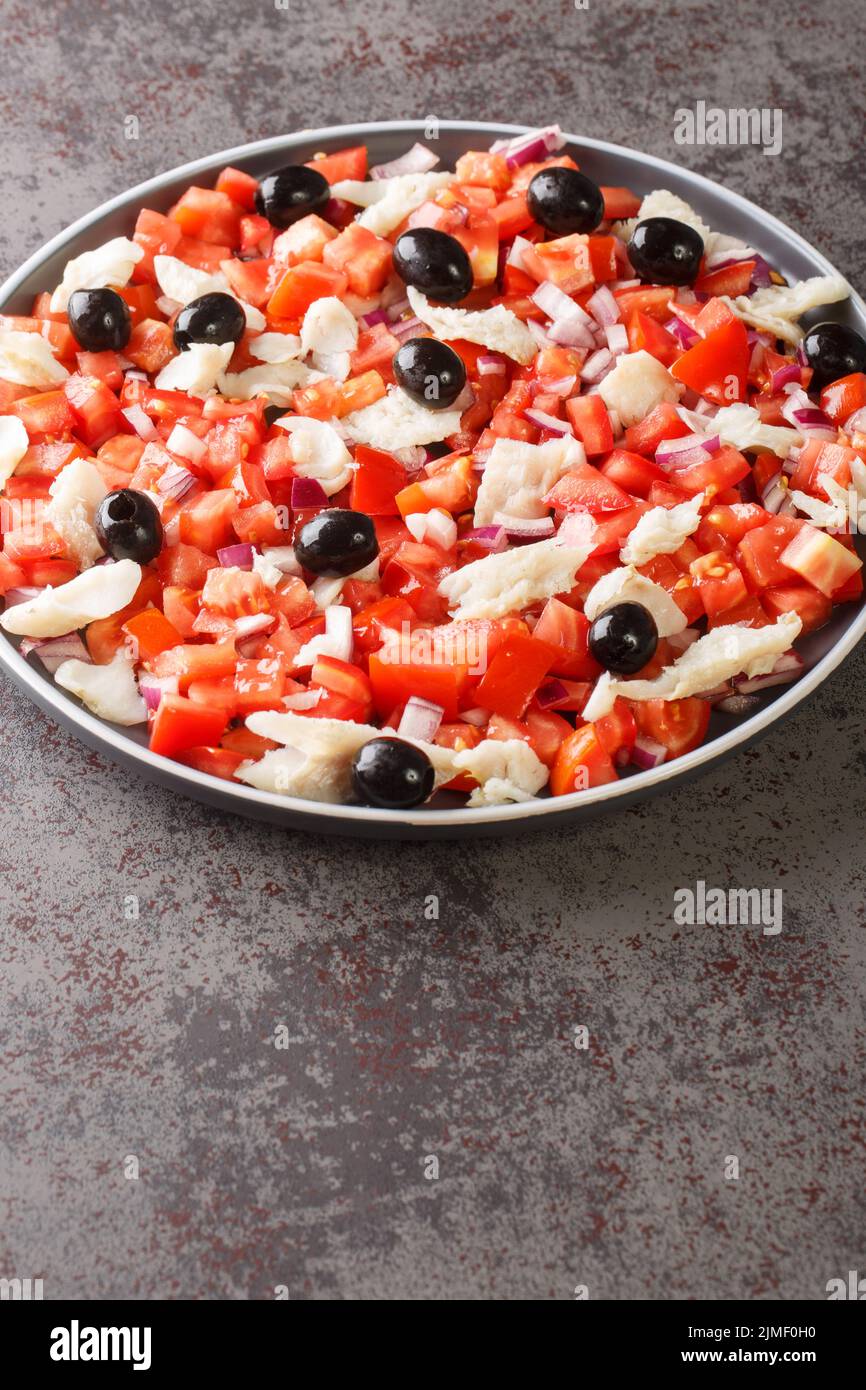 Catalan codfish salad as known as esqueixada, with cod, tomato onion ...