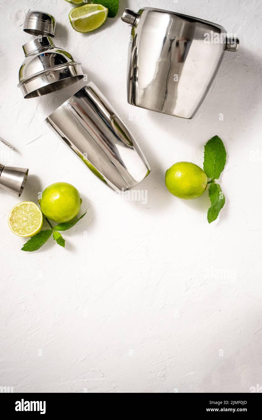 Top view of Bartenders coctail tools set. Steel shaker, measure, pliers ...