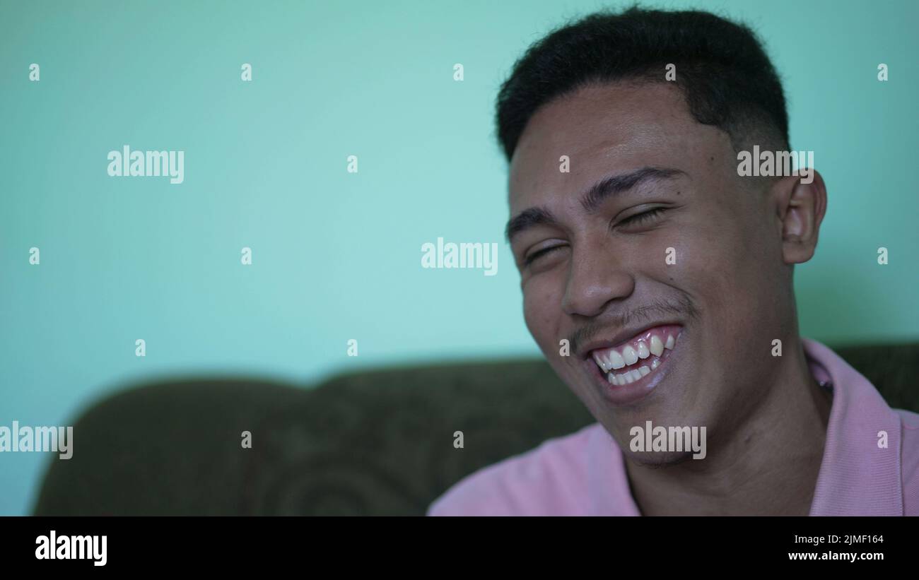 A hispanic young man laughing. Casual guy real life laugh and smile ...