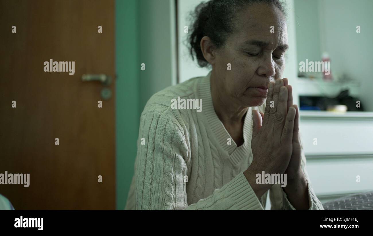 Brazilian older woman praying to God. Faithful and Spiritual elder lady ...