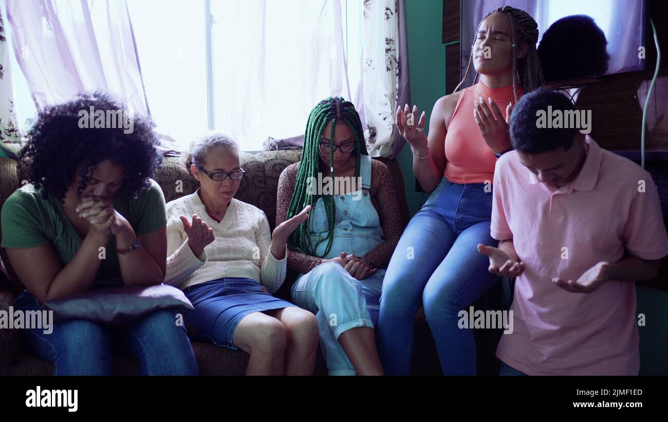A hispanic American family praying at home. Spiritual latin people ...