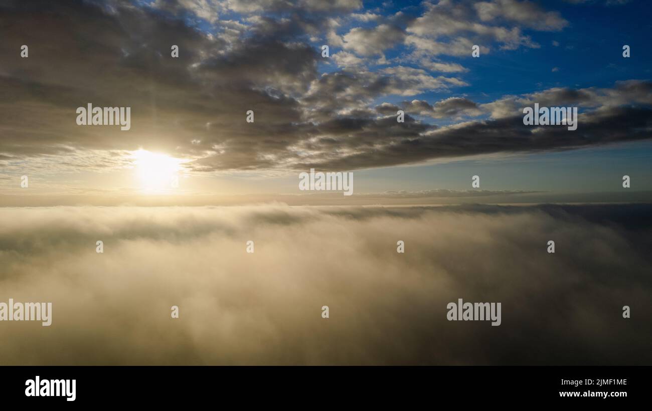 Aerial View. Flying in fog, fly in mist over the early morning clouds ...