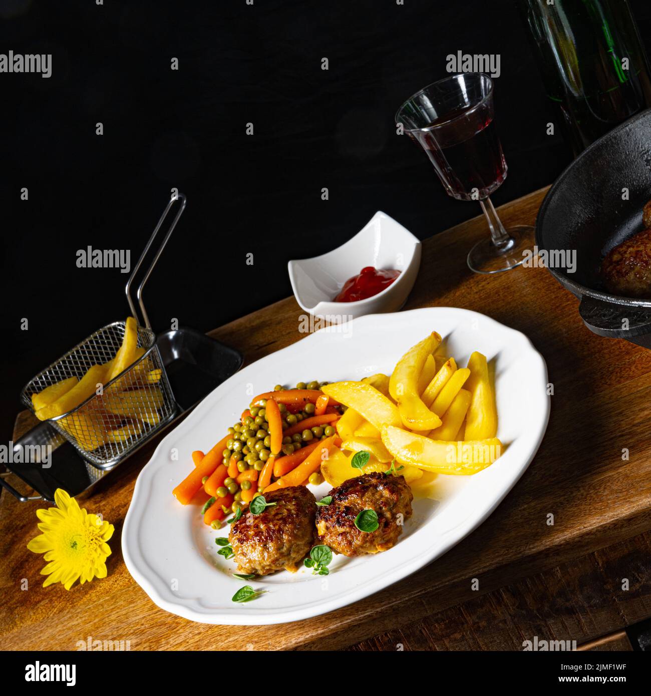 Homemade meatballs with french fries and vegetables Stock Photo - Alamy