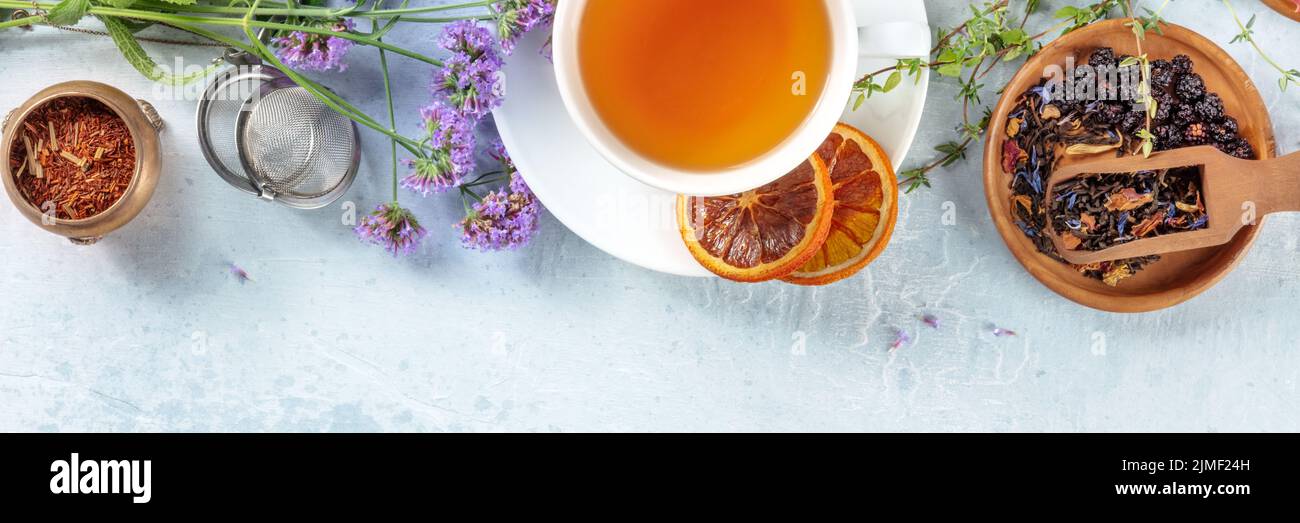 Tea panorama with a place for text, with a tea strainer, flowers, and ...