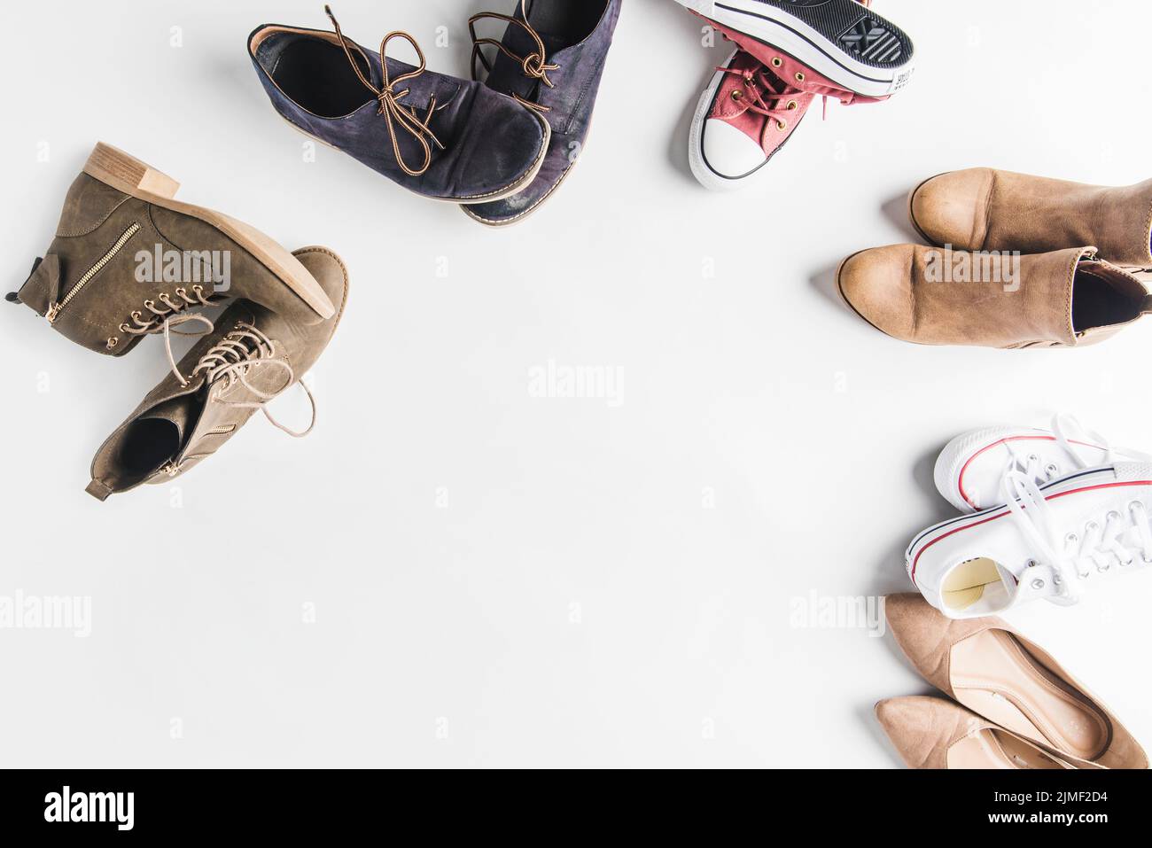 A top view of diverse shoes on a white surface Stock Photo - Alamy