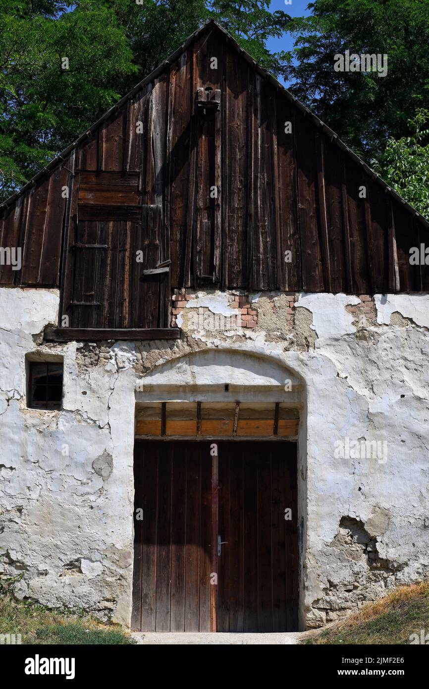 Austria, barn and old wine cellar built into the mountainside in the ...