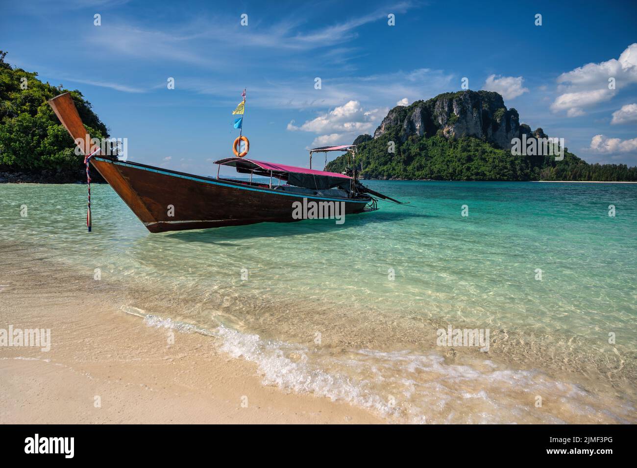 Tropical islands view with long tail boat ocean blue sea water and ...
