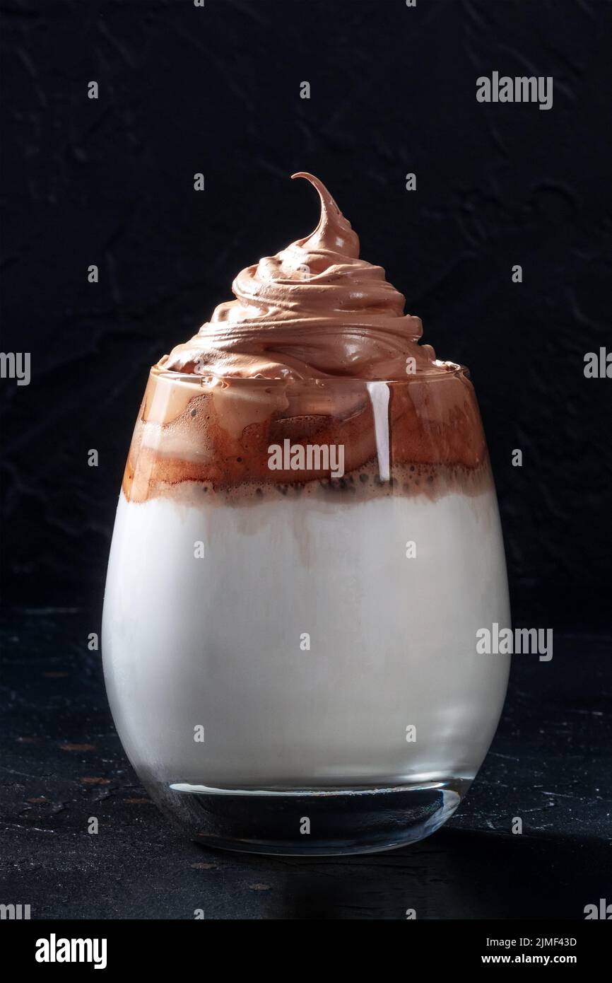 Dalgona cold coffee in a glass on a black background. Trendy Korean ...